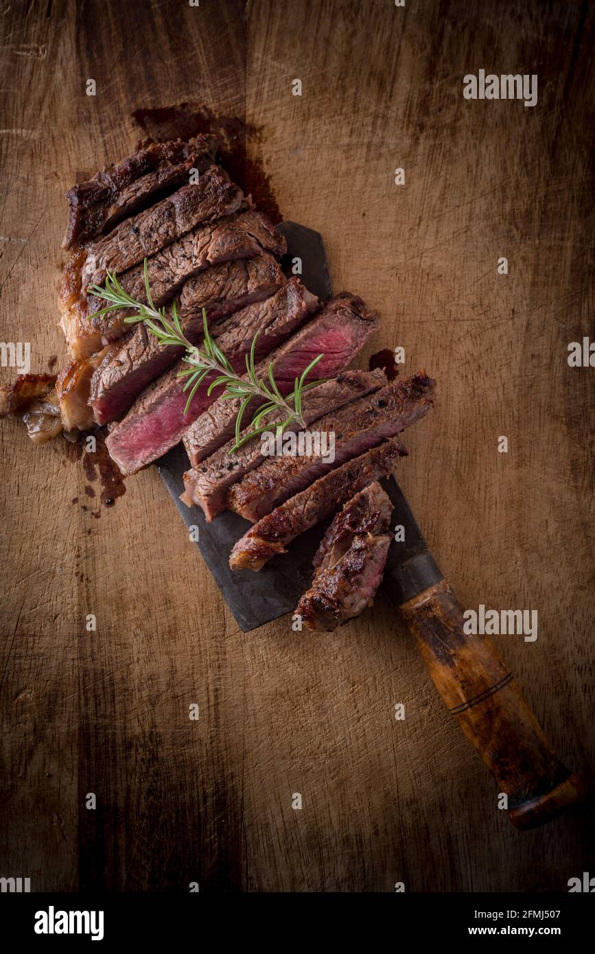 Overhead view of tasty tender meat pieces with fresh herb sprig on top ...