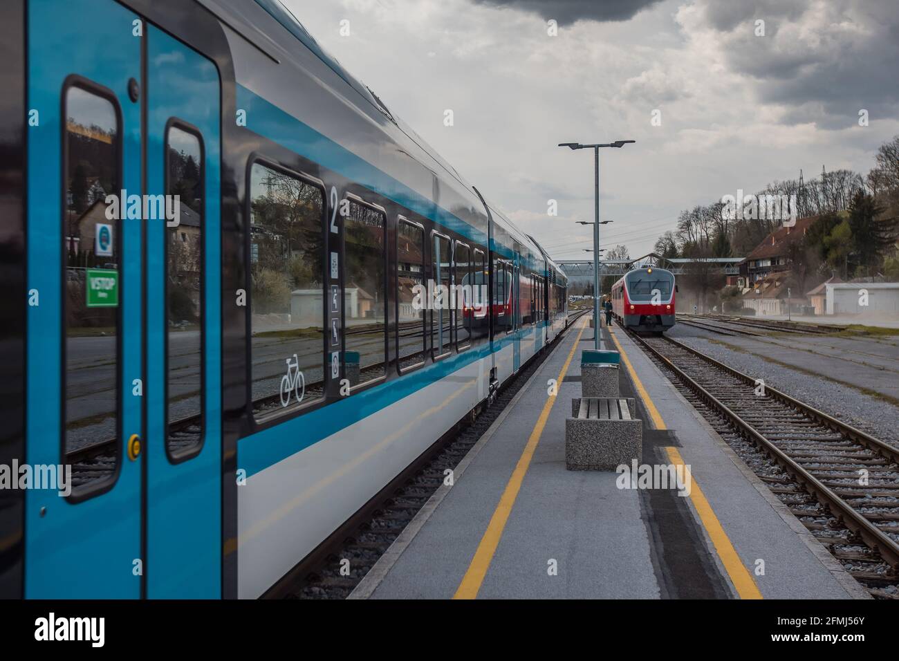 Old versus new passenger train standing on a platform. Concept of ...