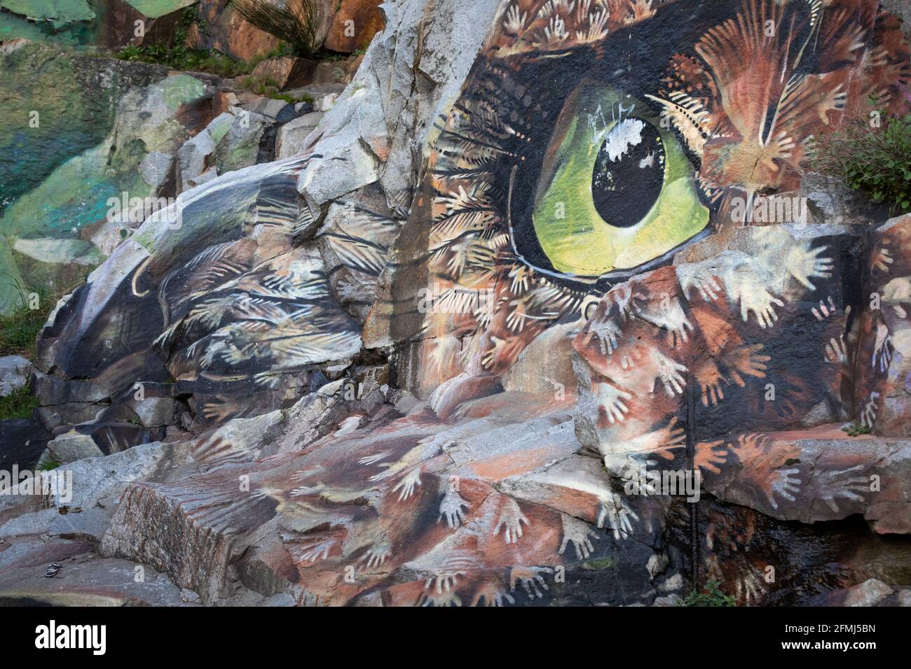 Creative element of graffiti of bird on rough rocky cliff in ...