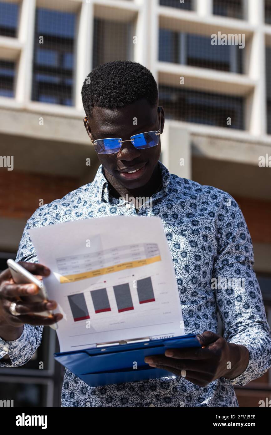 Young intelligent African American male entrepreneur in eyewear with ...