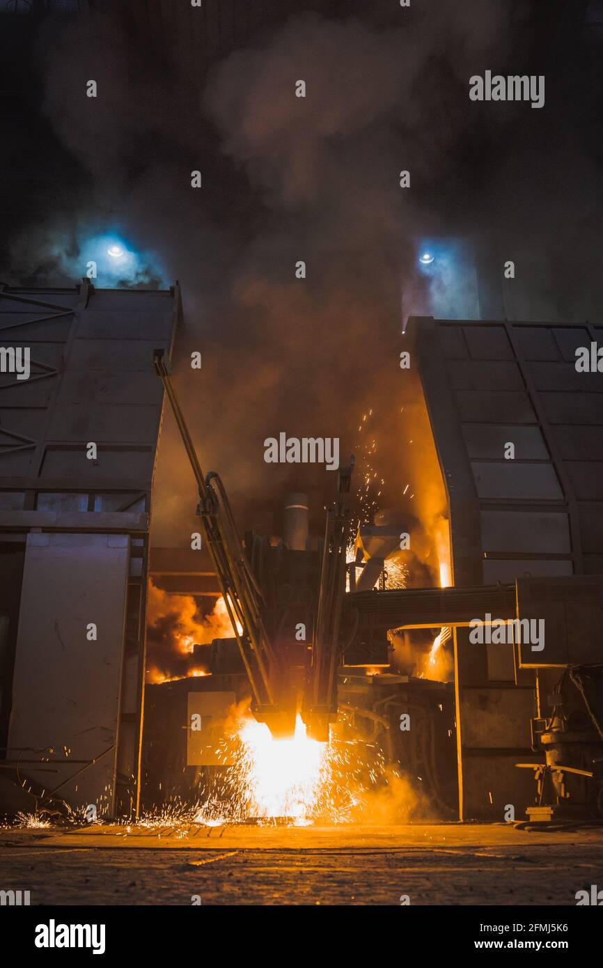 Big steel mill or iron furnace at work. Process of injecting oxygen to ...
