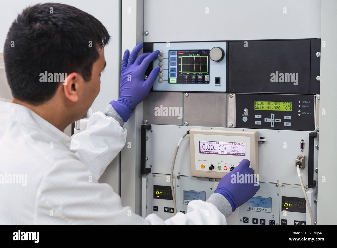 Crop concentrated professional male laboratory assistant in white robe ...