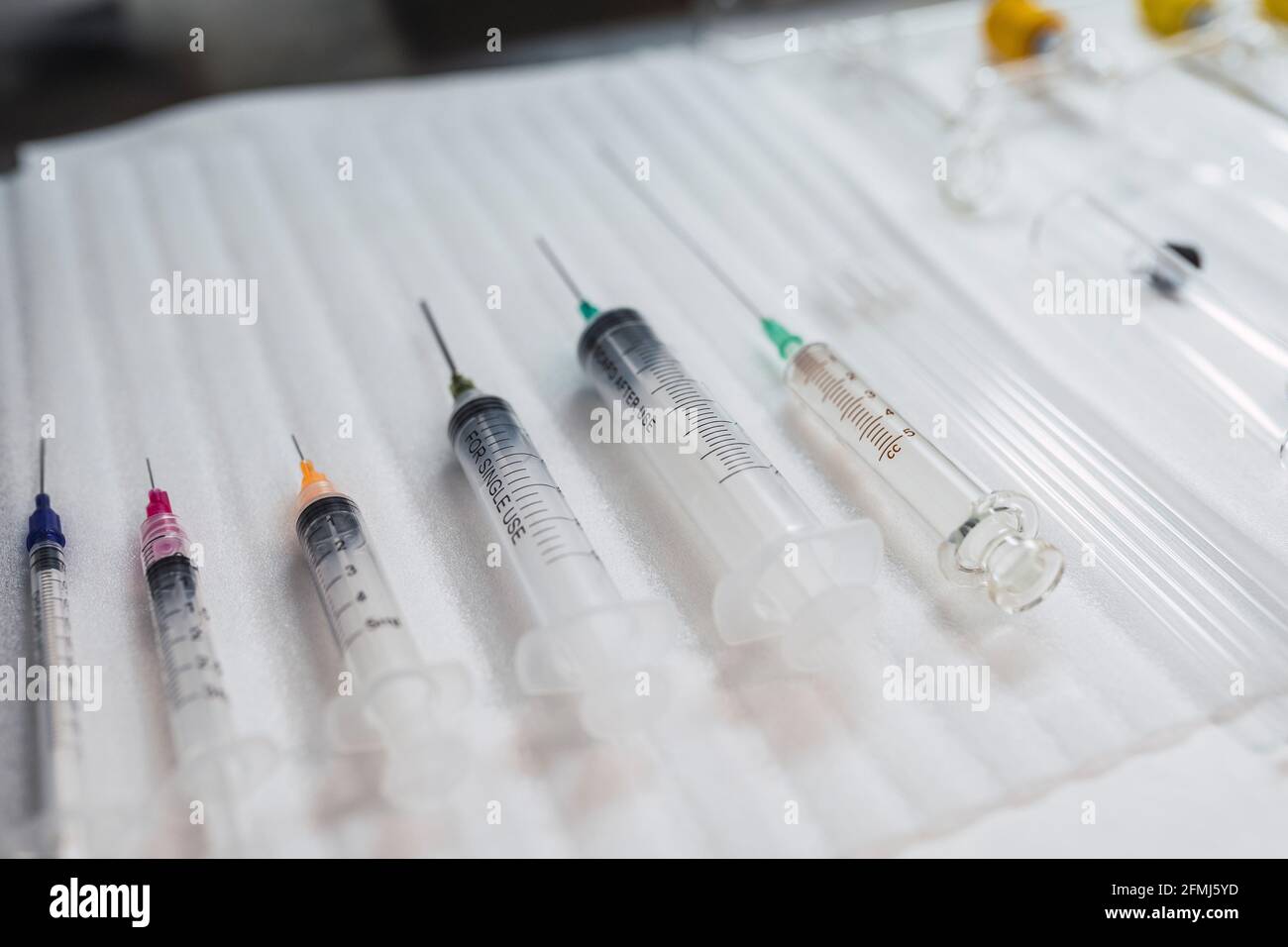 Composition of sterile medical syringes of different sizes arranged on ...