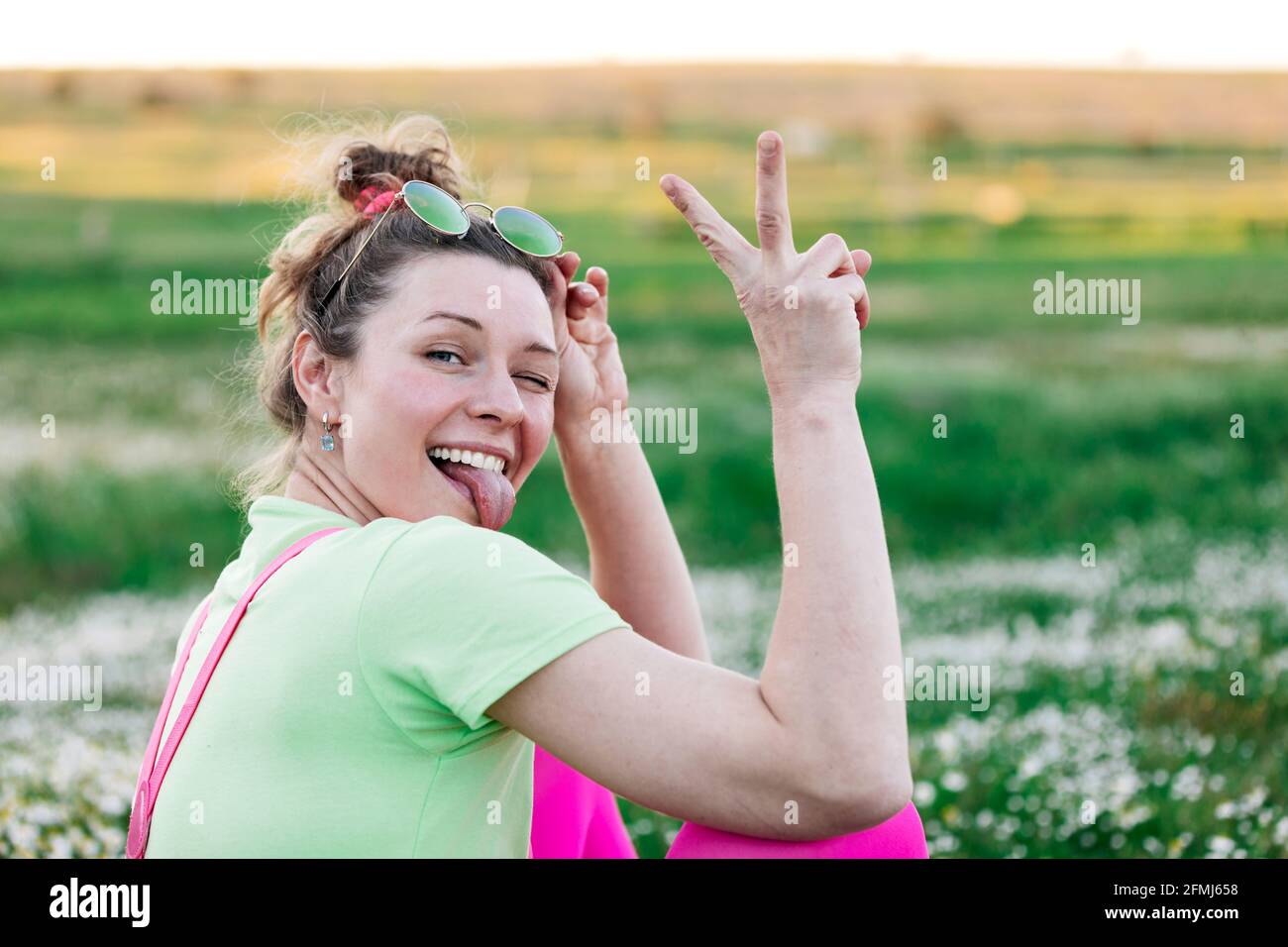 Side view cheerful young female wearing colorful bright outfit sitting ...