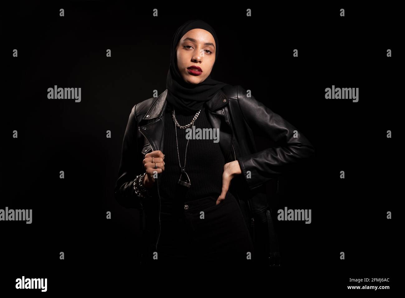 Attractive young Islamic female wearing black outfit with leather ...
