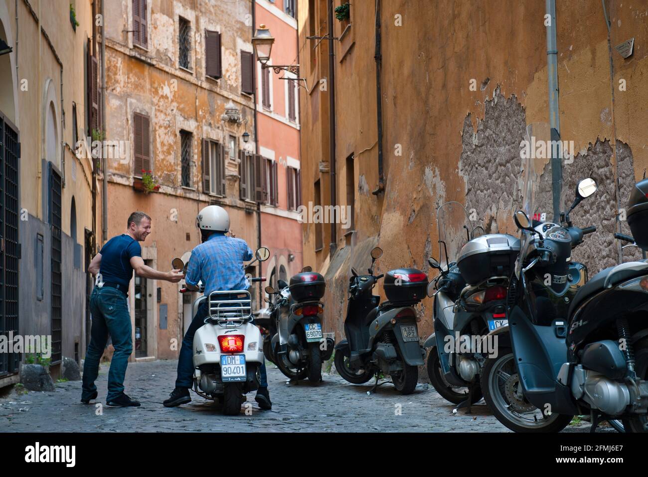 Italian men talking in the street Stock Photo - Alamy