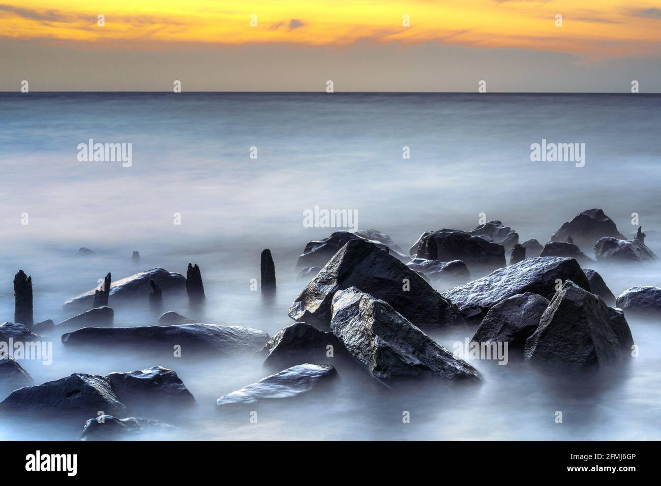 Rocky coast of sea. Slow shutter speed for smooth water level and ...
