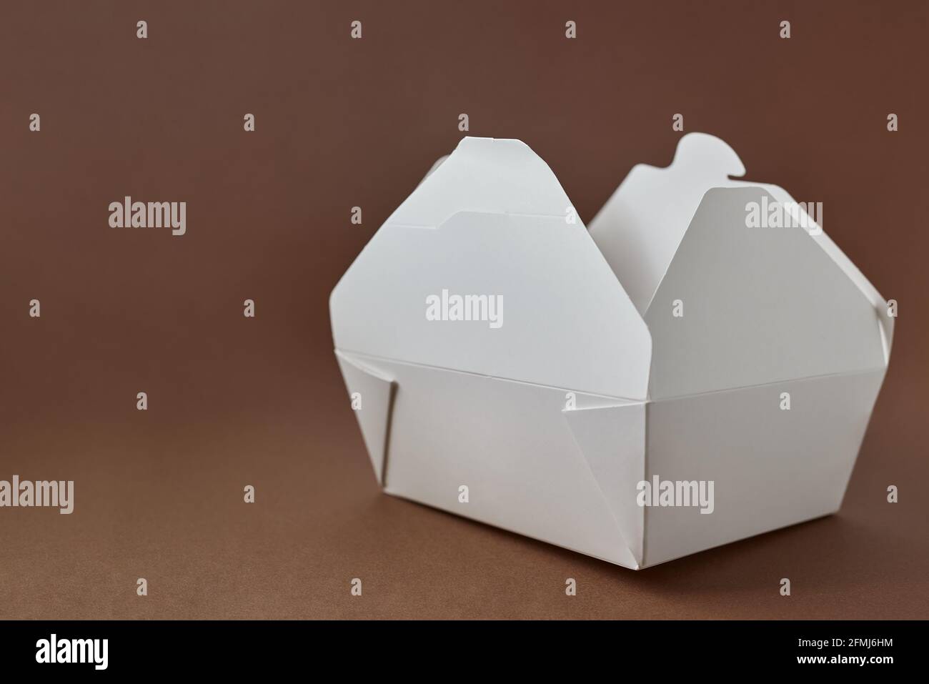 White paper food container on brown background Stock Photo - Alamy