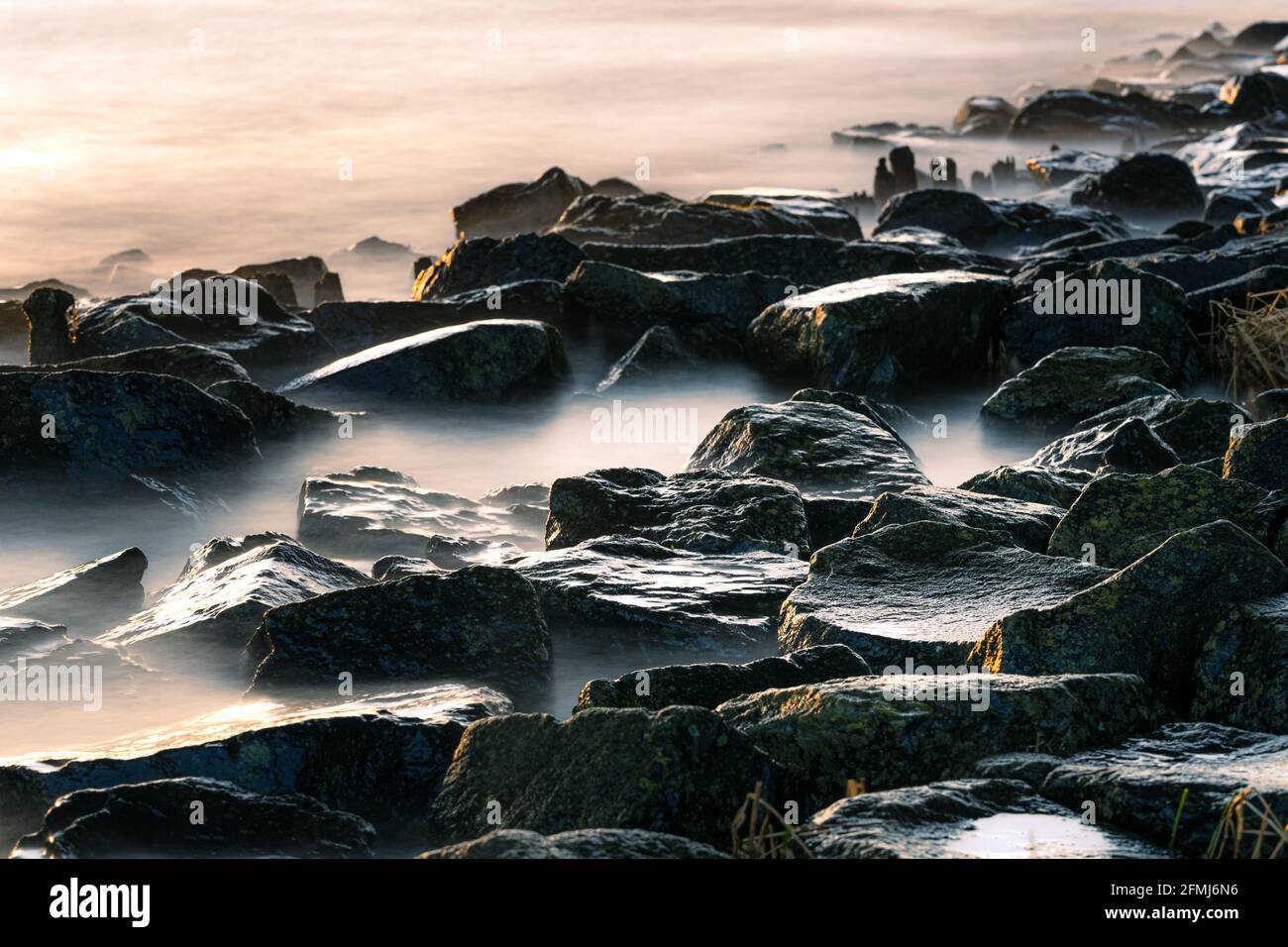 Rocky coast of sea. Slow shutter speed for smooth water level and ...