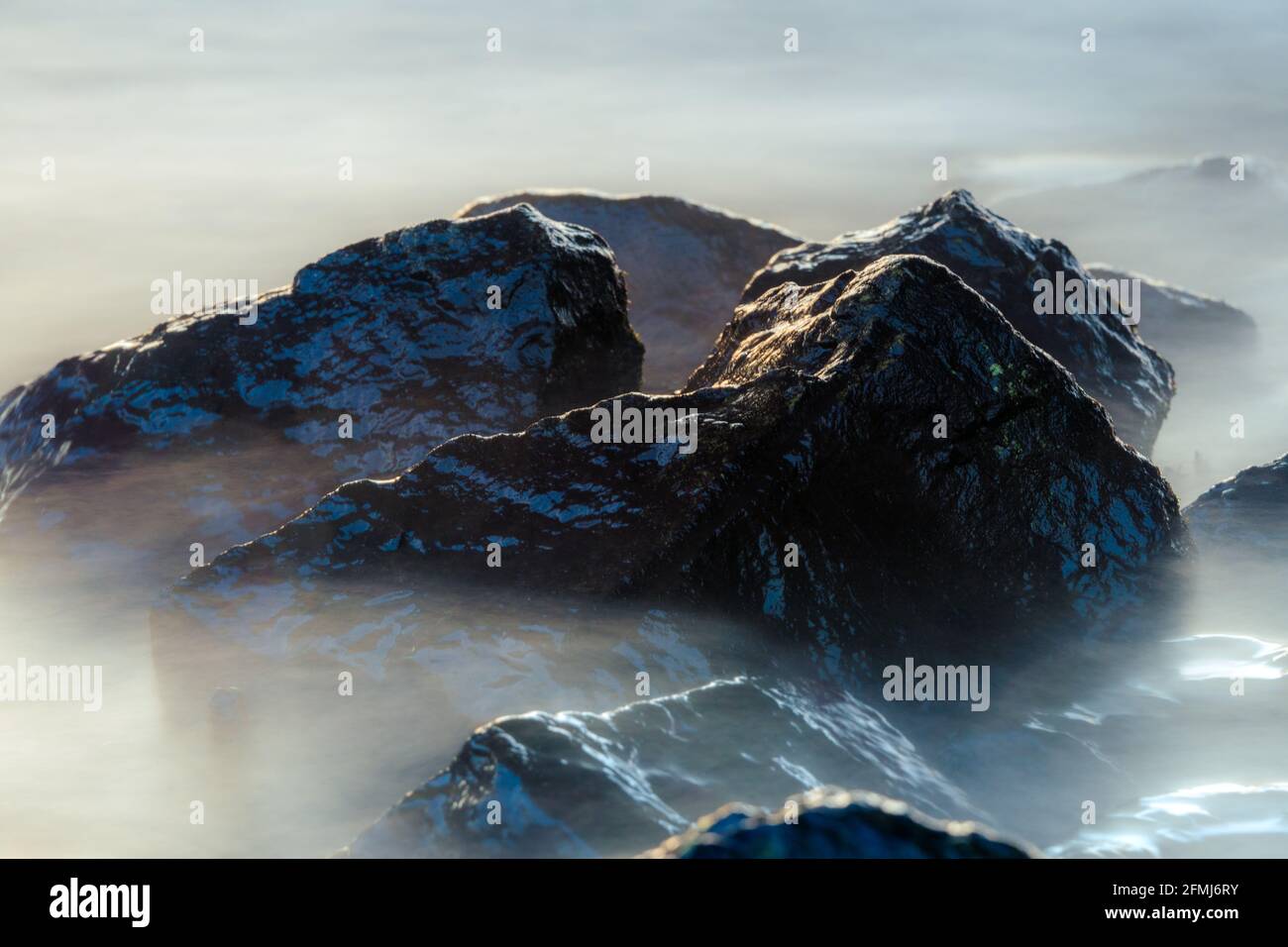 Rocky coast of sea. Slow shutter speed for smooth water level and ...