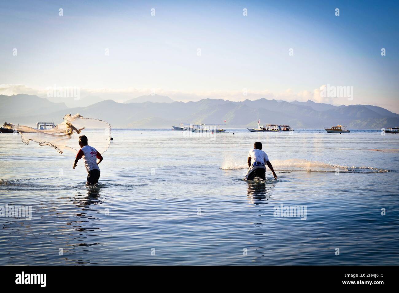 Indonesian fisherman casting nets Stock Photo - Alamy