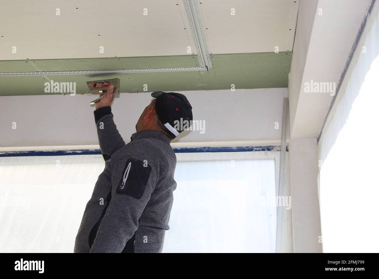 Man working on drywall construction Stock Photo - Alamy