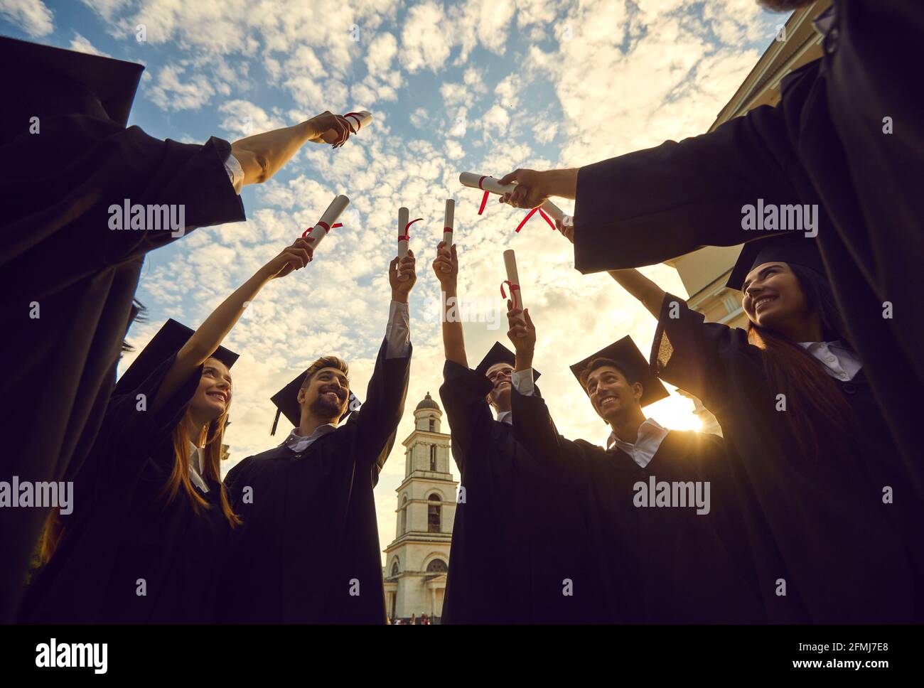Graduates raise up diplomas hi-res stock photography and images - Alamy