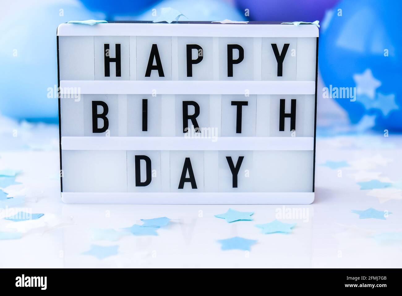 Lightbox with text HAPPY BIRTHDAY on Abstract defocused blurred festive ...