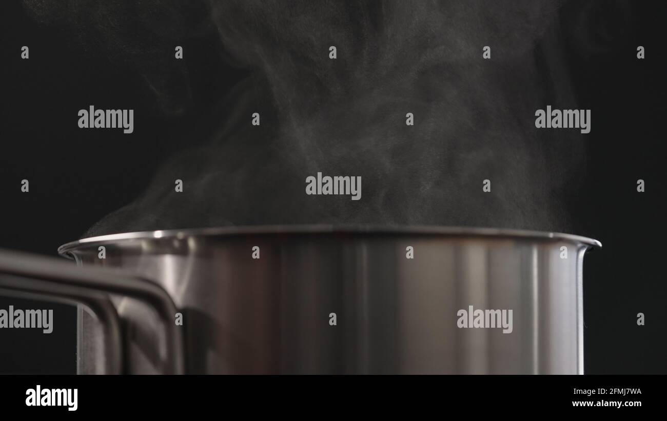 Steam rising from saucepan over black background, wide photo Stock ...