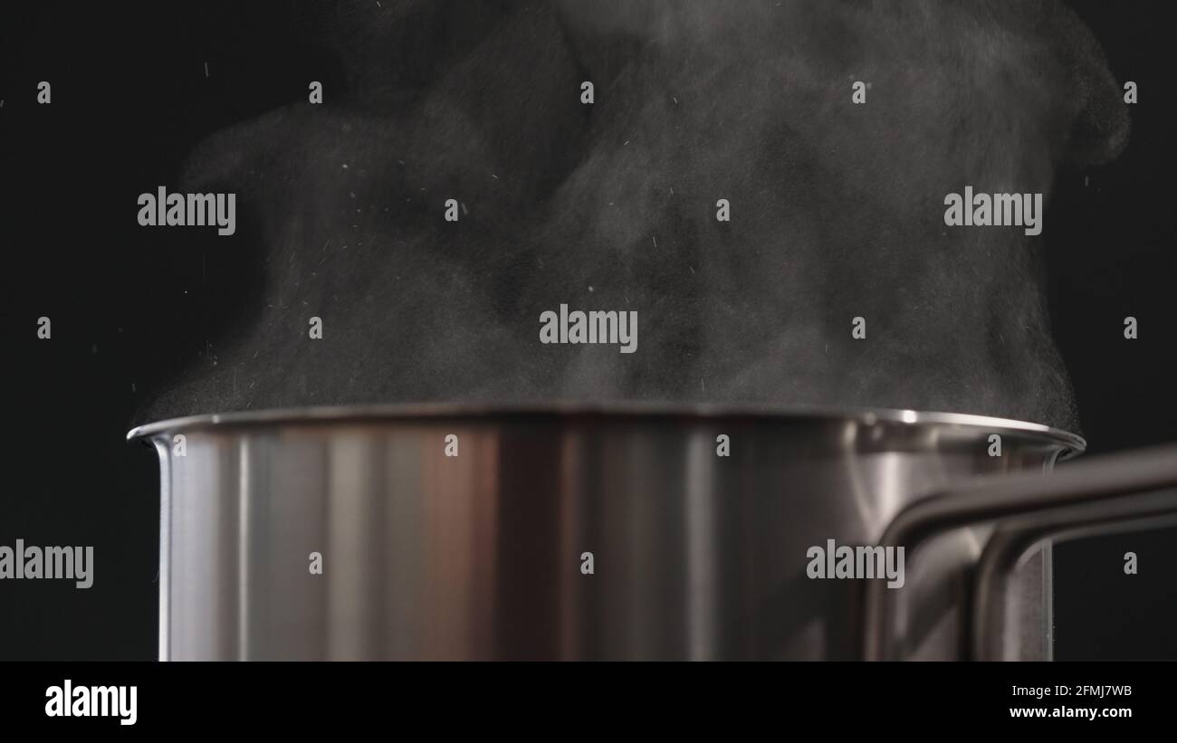 Steam rising from saucepan over black background, wide photo Stock ...