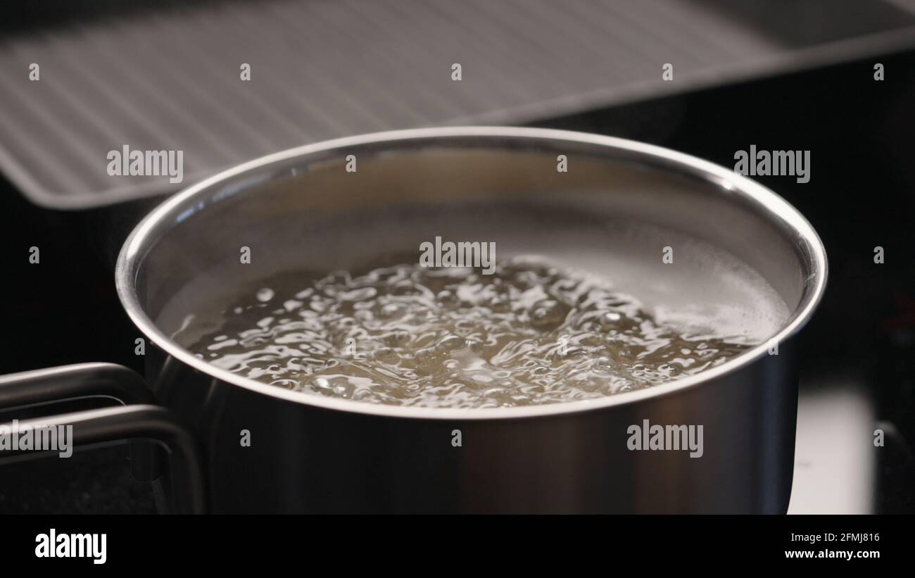 boiling penne in steel pot closeup, wide photo Stock Photo - Alamy