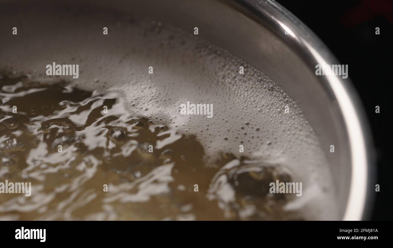 boiling penne in steel pot closeup, wide photo Stock Photo - Alamy