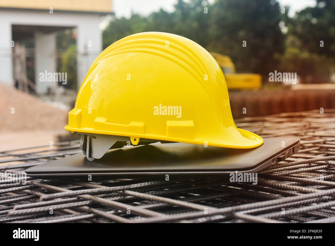 Yellow hard hat safety equipment in site construction Stock Photo - Alamy