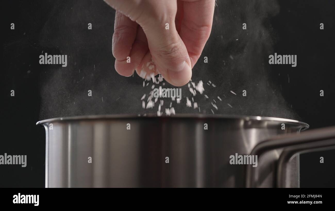 Man salting boiling water hi-res stock photography and images - Alamy