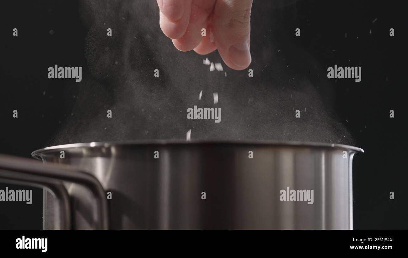 Man salting boiling water hi-res stock photography and images - Alamy
