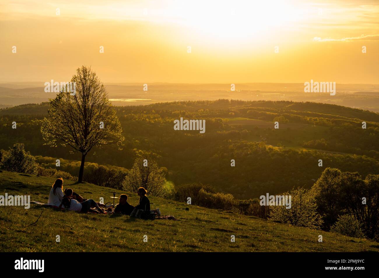 Young People enjoying Golden Sunset and smoking Shisha Stock Photo - Alamy
