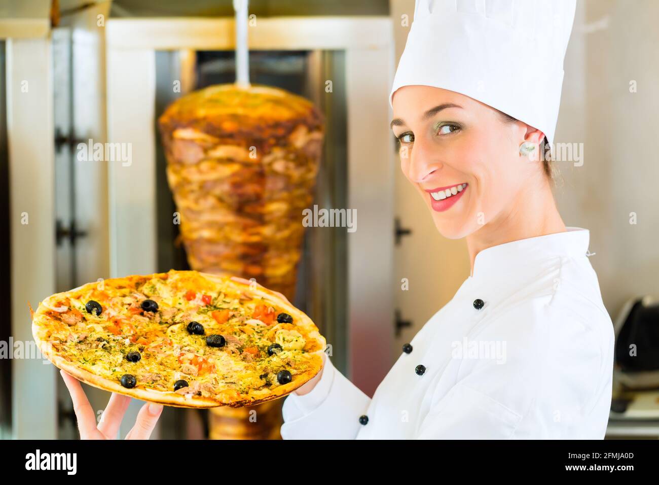 Doner kebab - friendly female vendor in a Turkish fast food eatery ...