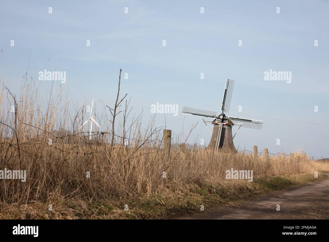 Old windmill and modern turbine in the Netherlands, catching dutch wind Stock Photo - Alamy