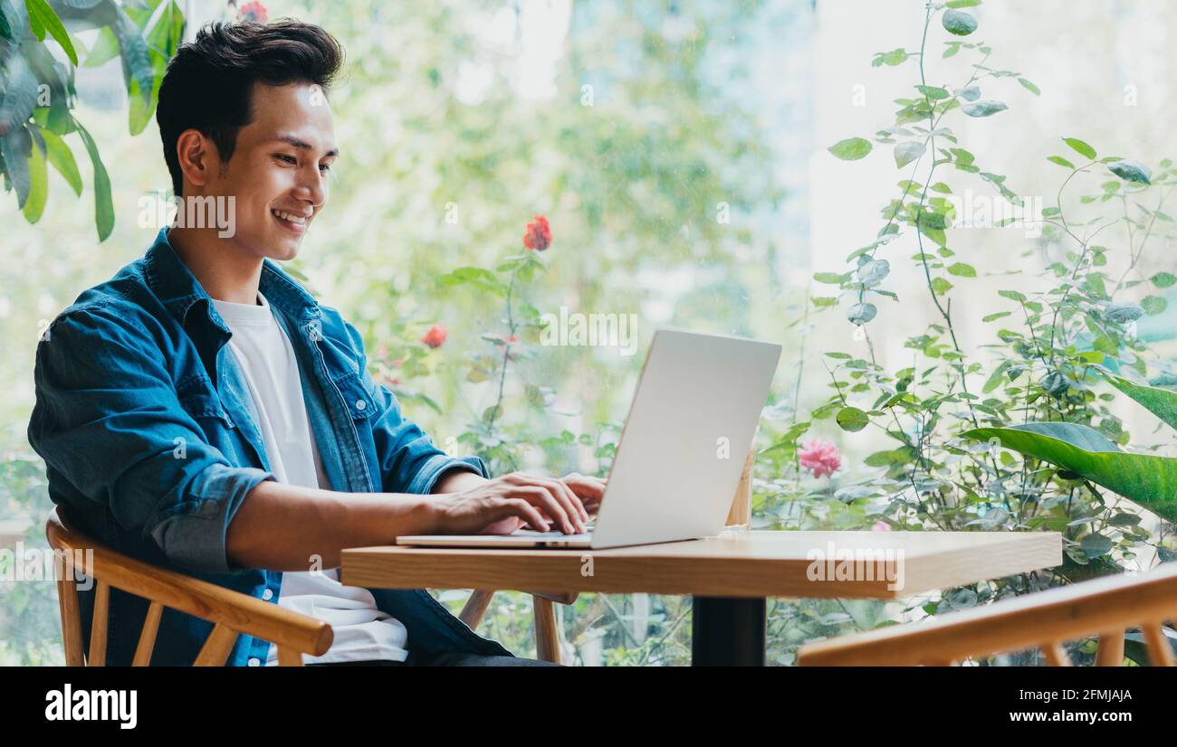 Young Asian man working at coffee shop Stock Photo - Alamy