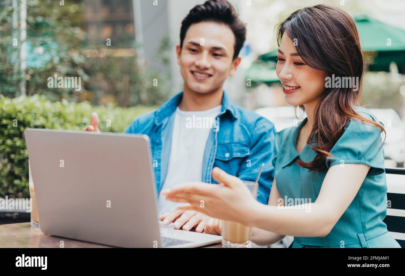 Young Asian people working together at coffee shop Stock Photo - Alamy