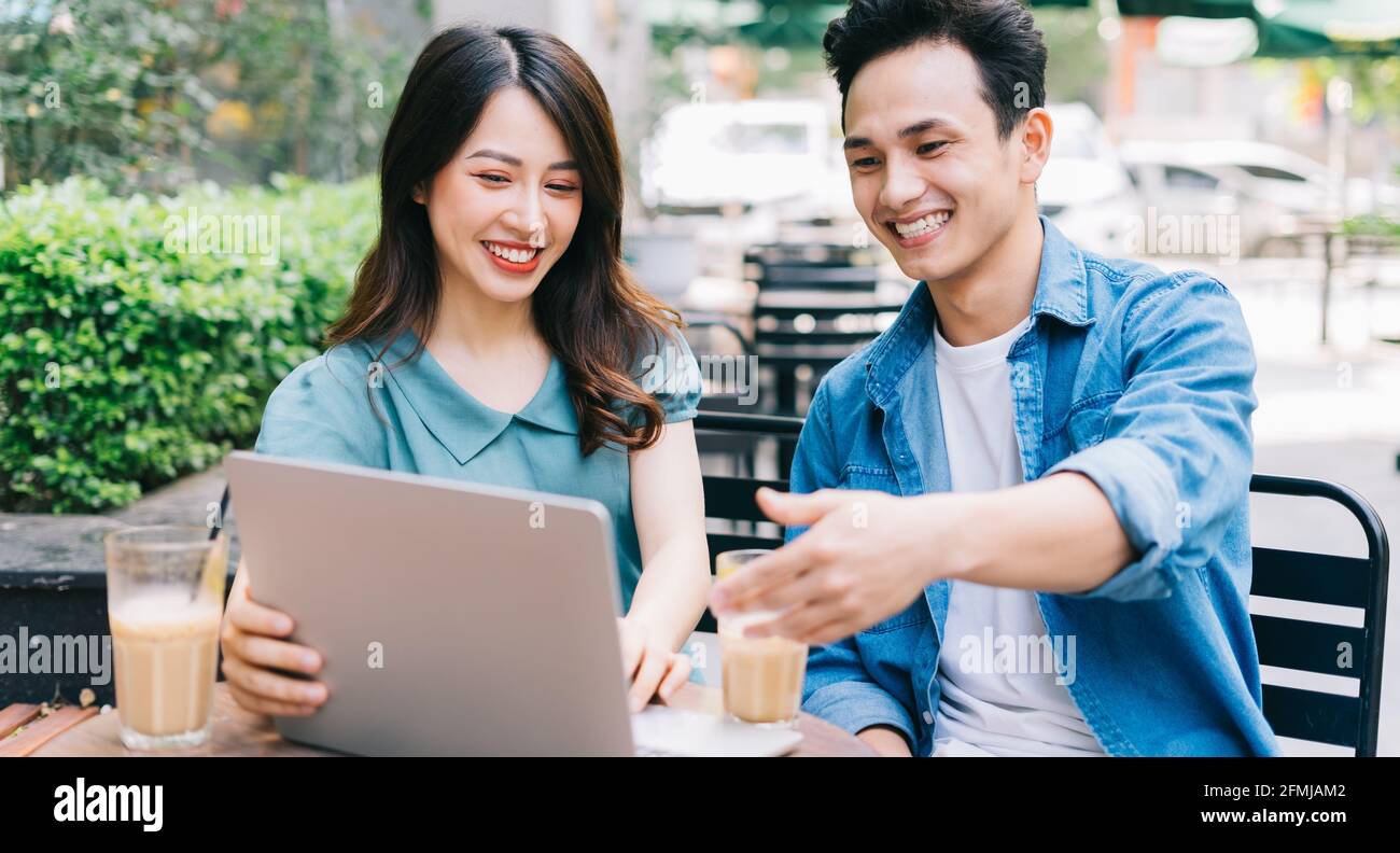 Young Asian people working together at coffee shop Stock Photo - Alamy