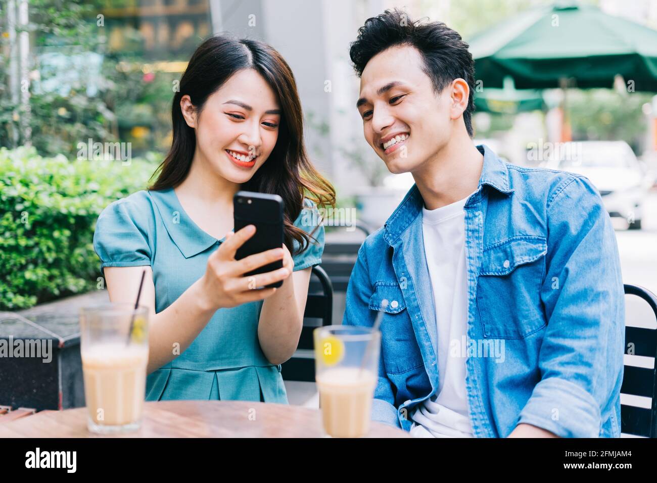 Young Asian people working together at coffee shop Stock Photo - Alamy