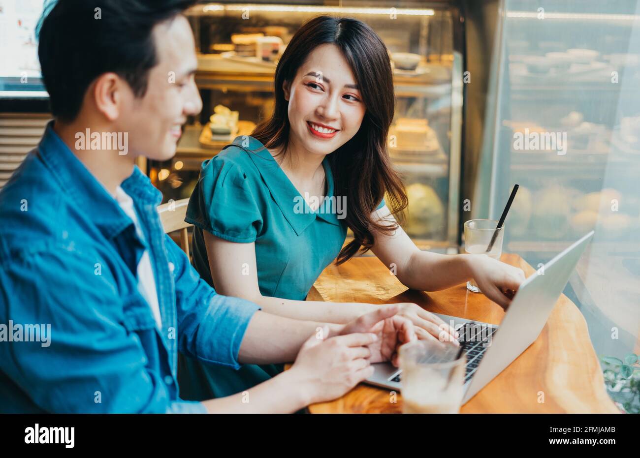 Young Asian people working together at coffee shop Stock Photo - Alamy