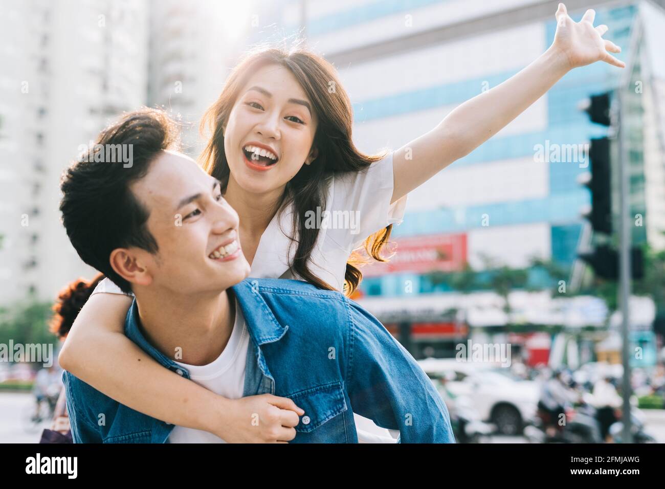 Boyfriend is carrying his girlfriend on his back Stock Photo - Alamy
