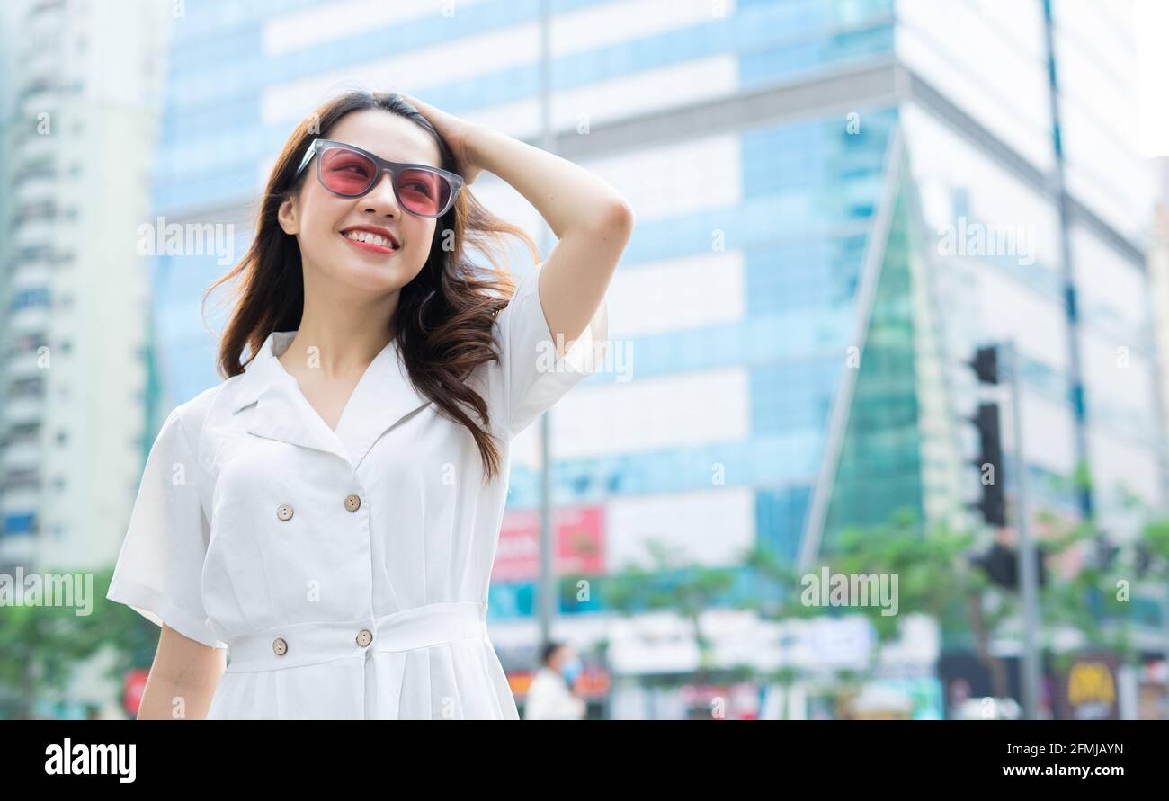 Young Asian woman walking on the street Stock Photo - Alamy