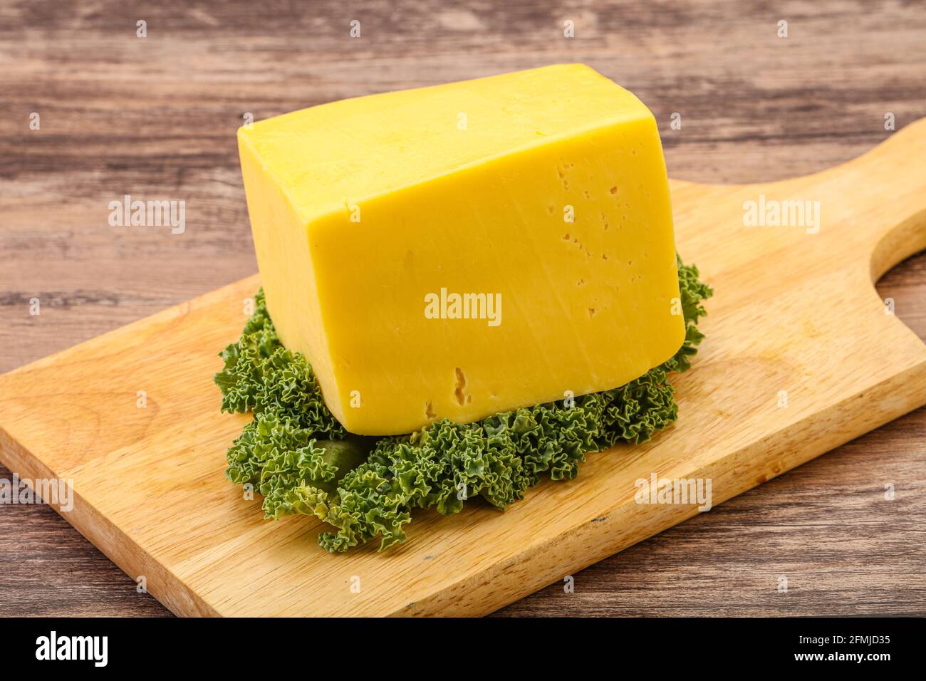 Yellow tilsiter cheese dairy product brick Stock Photo - Alamy