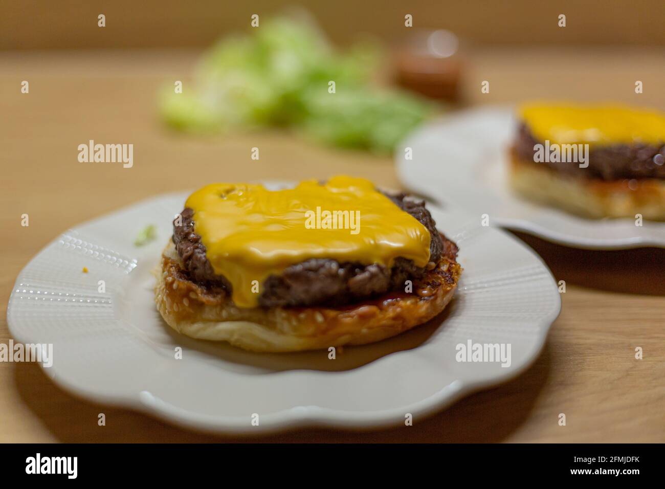 Process of cooking self made burgers at home. Cheesy burger on a white ...