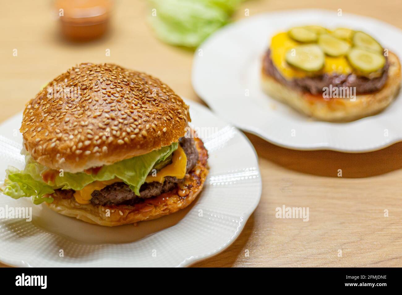 Process of cooking self made burgers at home. Cheesy burger on a white ...
