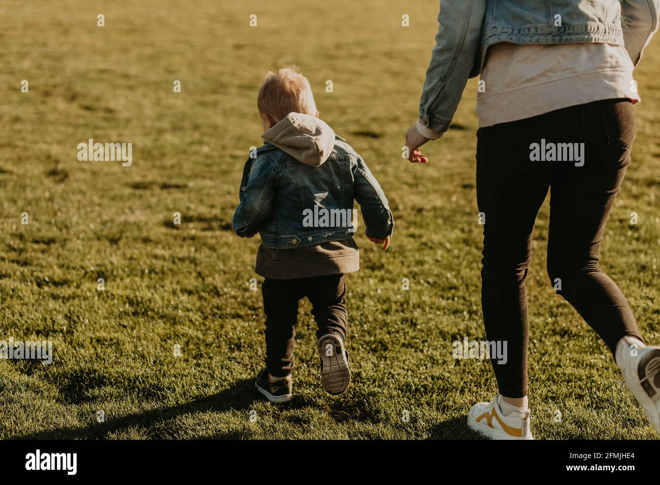 Beautiful happy family having fun and jogging outdoors, mom and baby ...