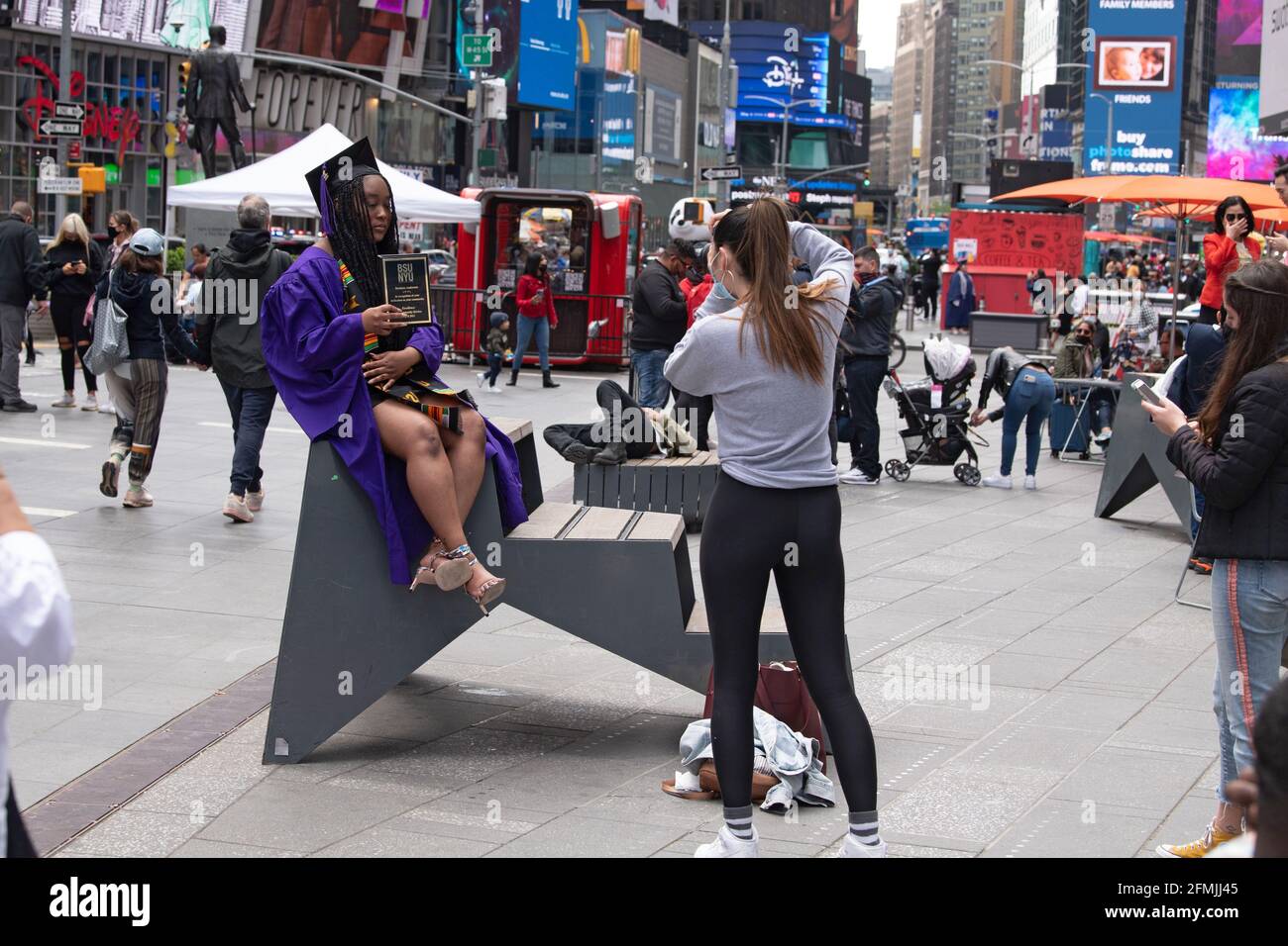 A woman takes pictures of Destinee Anderson, a recent graduate, in ...