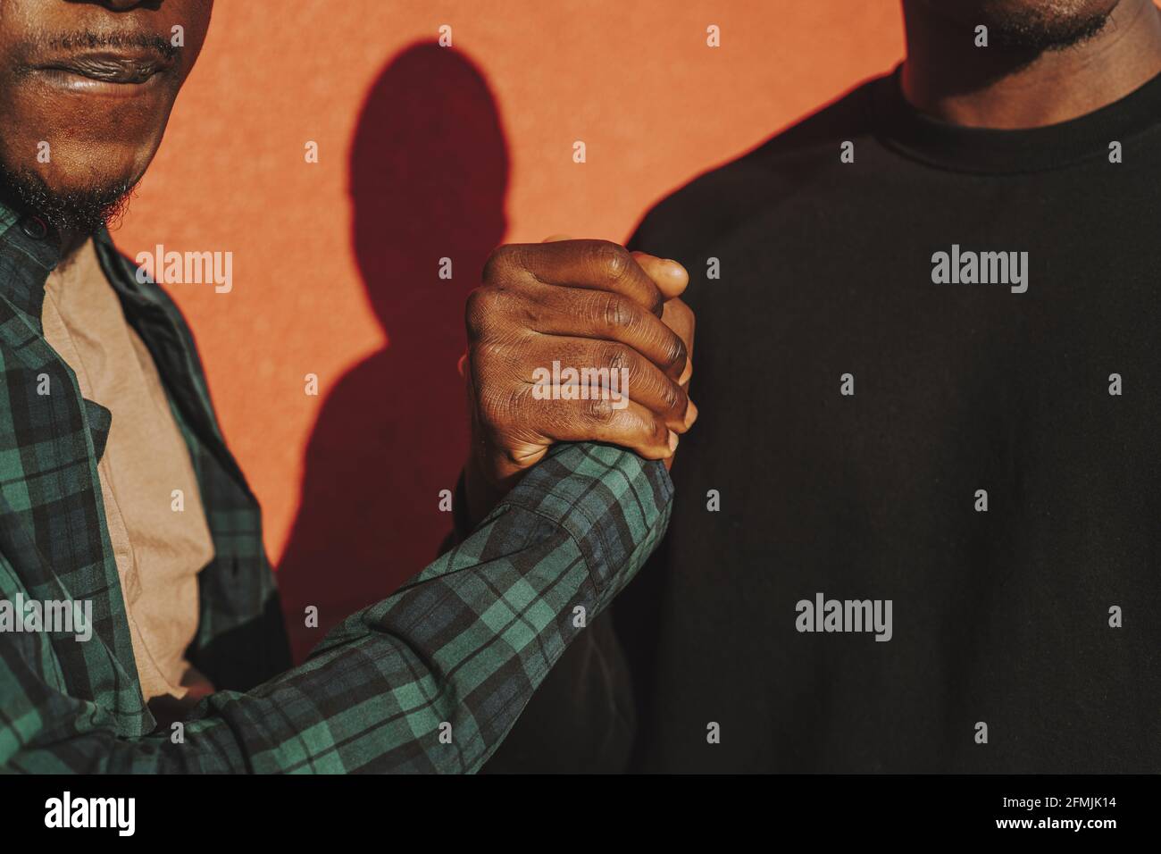 Shallow focus of two Black men with hands clenched together - concept ...
