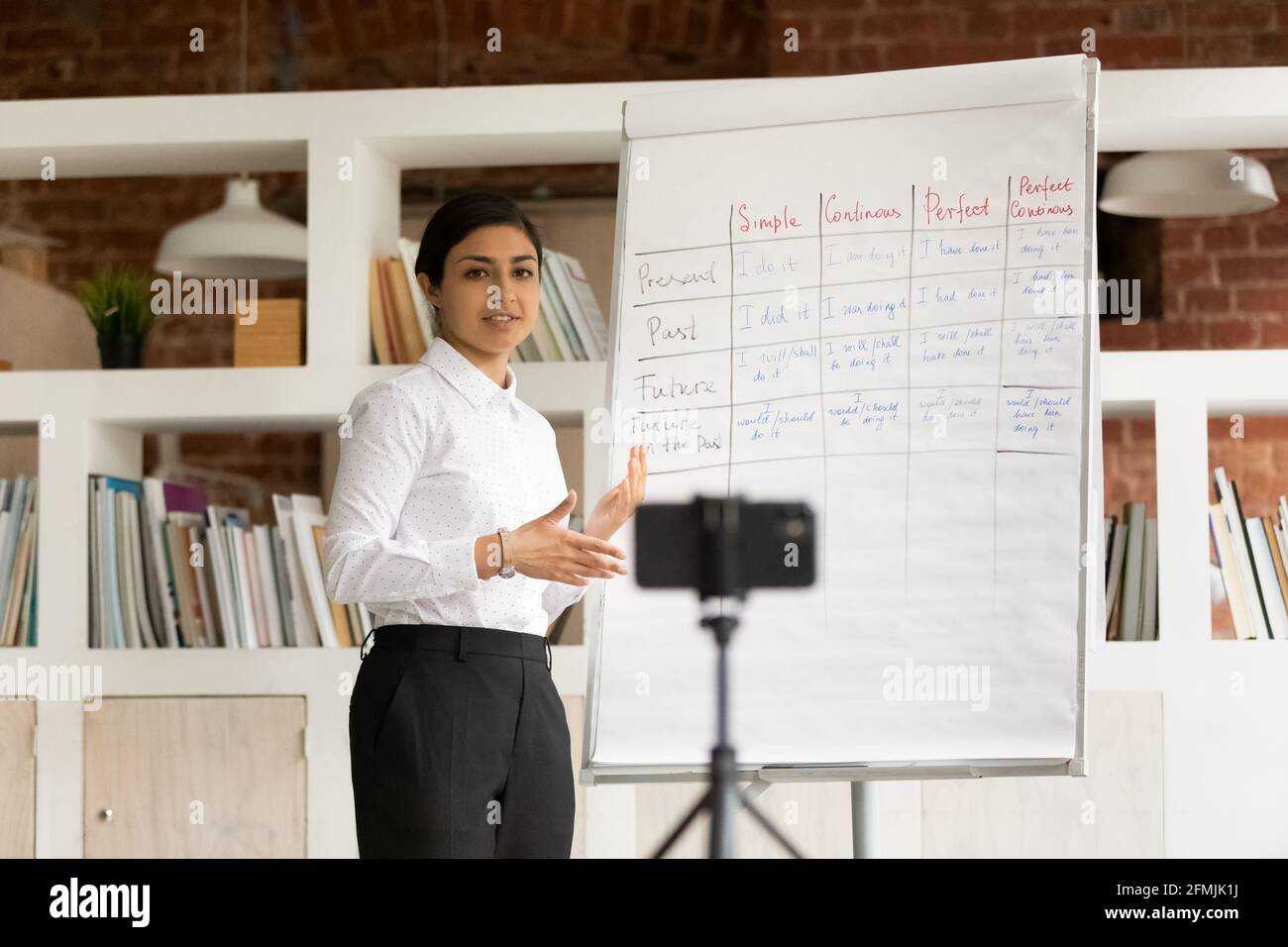 Indian woman teacher recording flip chart presentation, webinar on ...