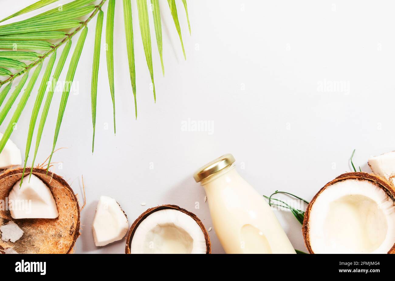 Coconut milk bottle, fruit and peel on gray background.Top view, hard ...