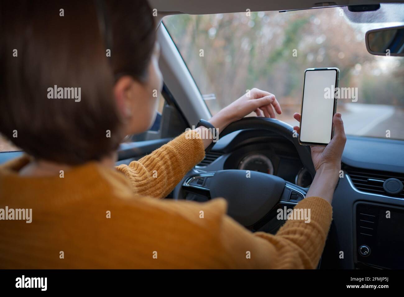 Mockup image of a woman holding and using mobile phone with blank ...