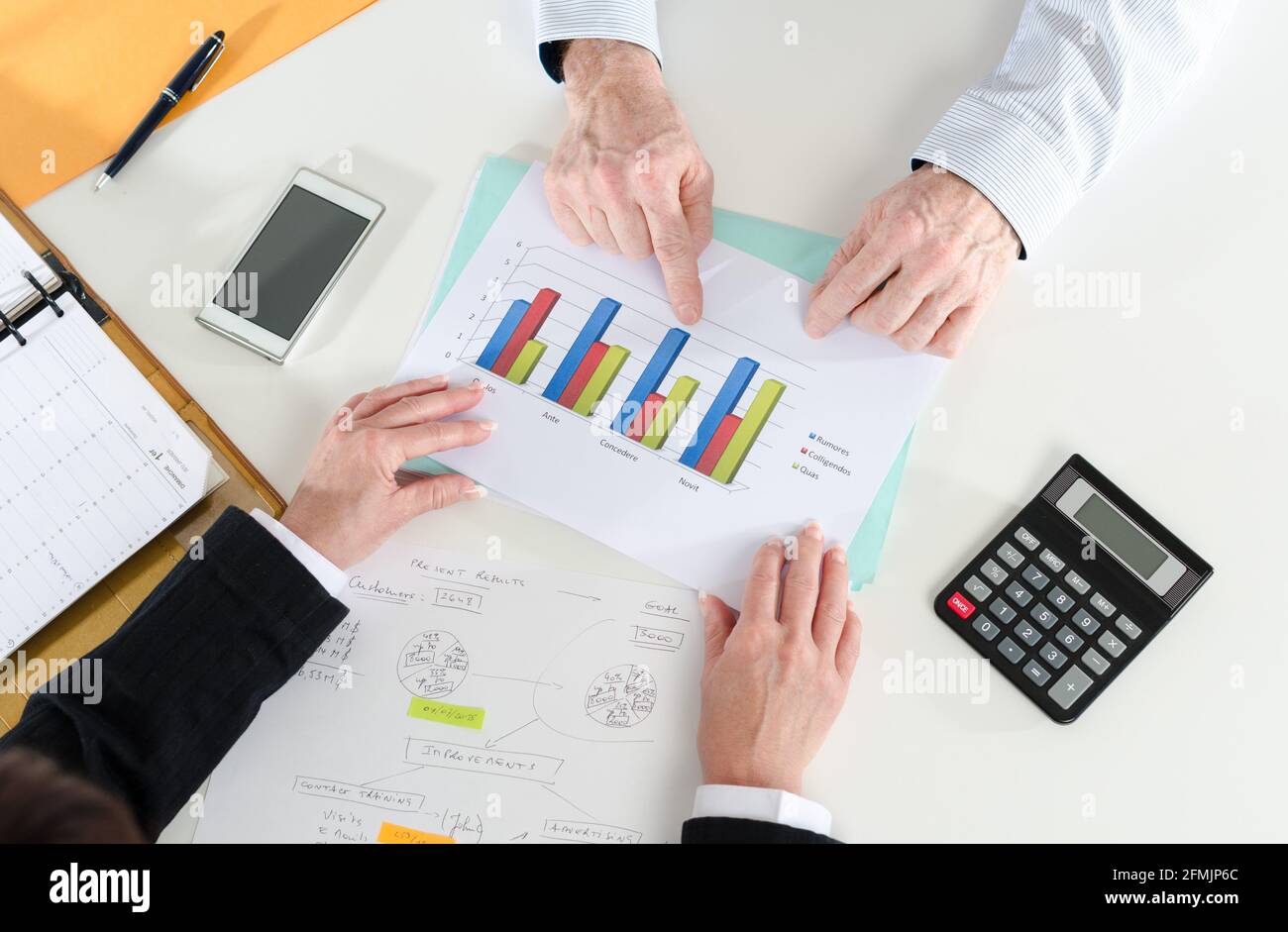 Businesspeople having a discussion about financial report at office ...