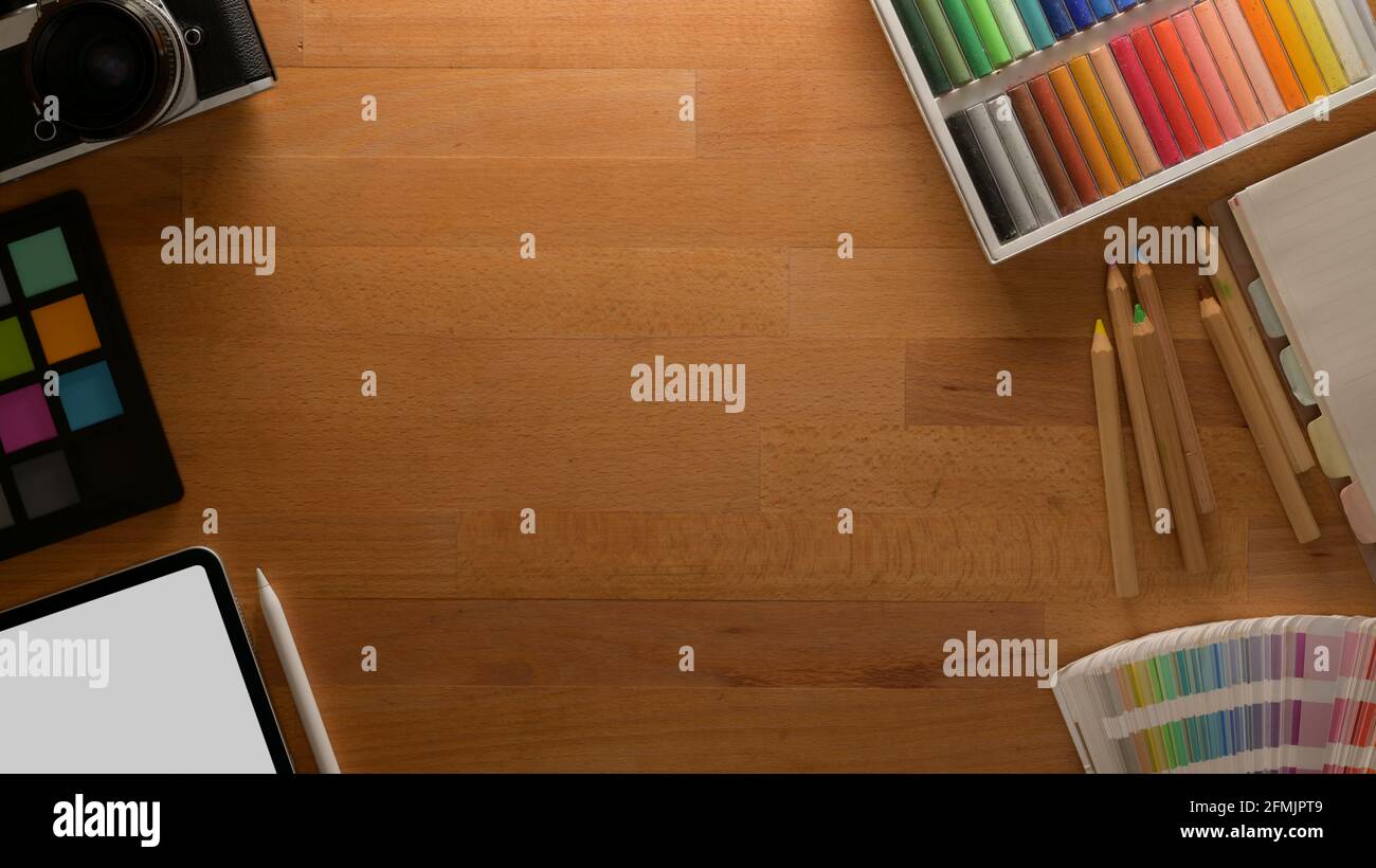 Top view of designer workspace with color checker, paint tools, mock up ...