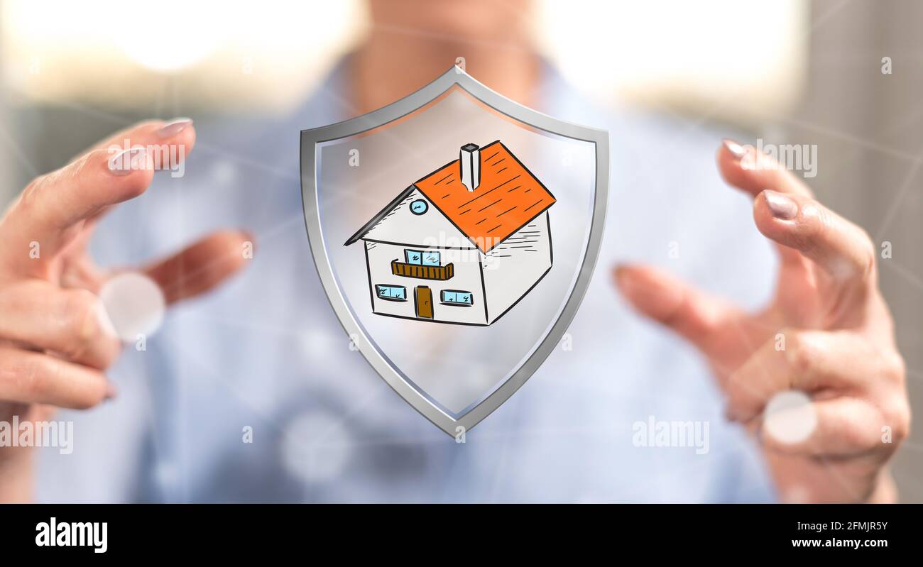 House protection concept between hands of a woman in background Stock ...