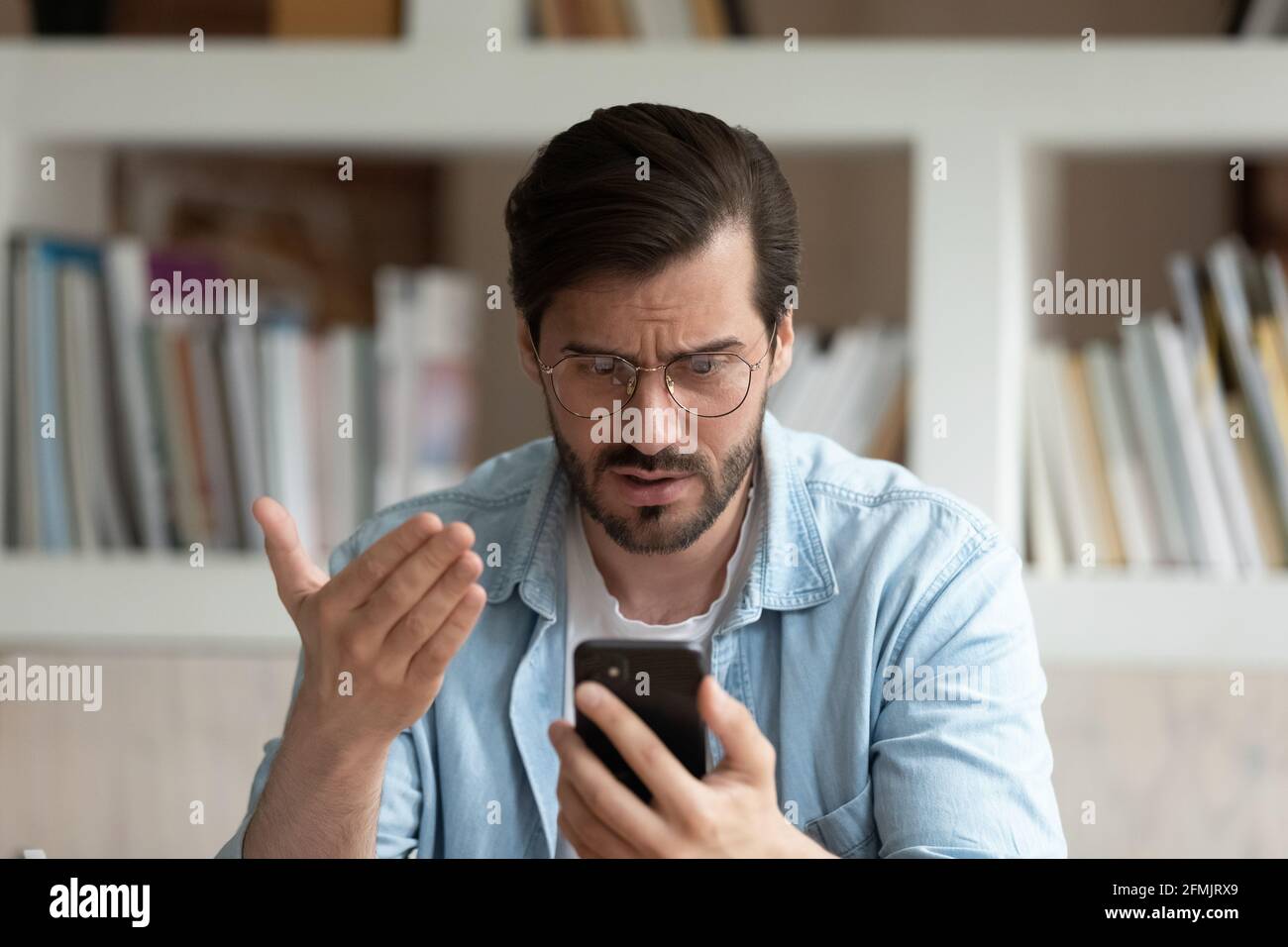 Frustrated looking at phone hi-res stock photography and images - Alamy