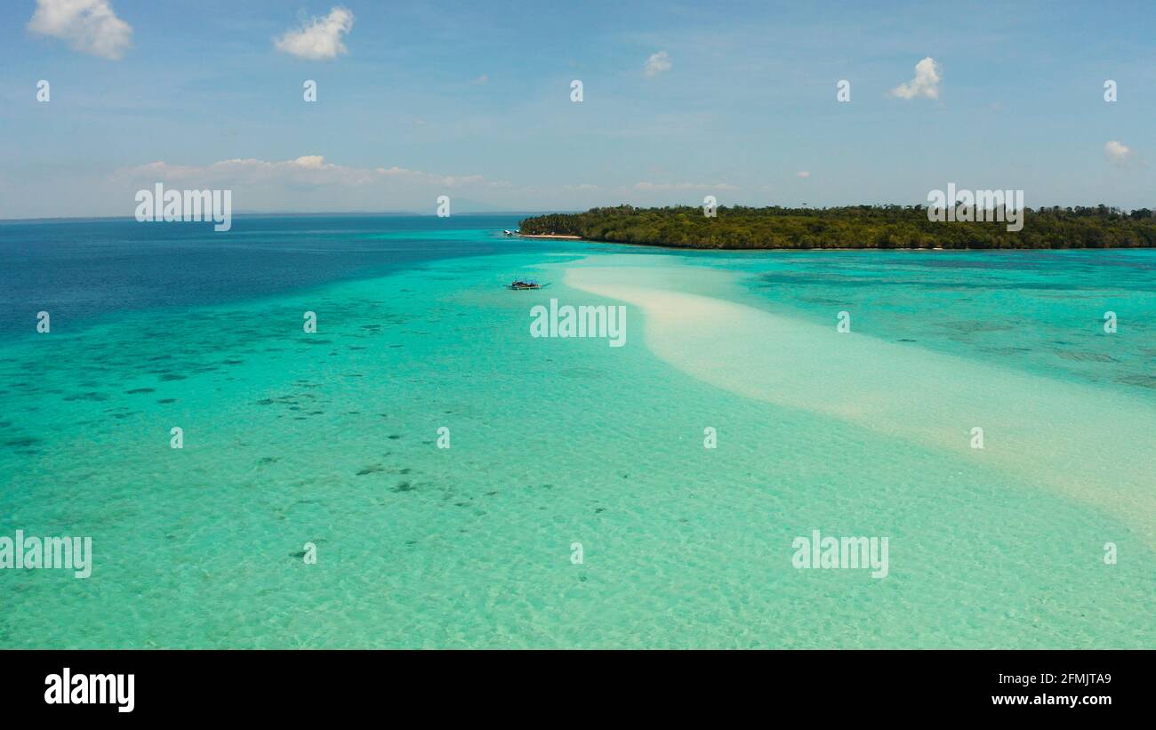 White sandy beach in the lagoon with turquoise water on a tropical ...