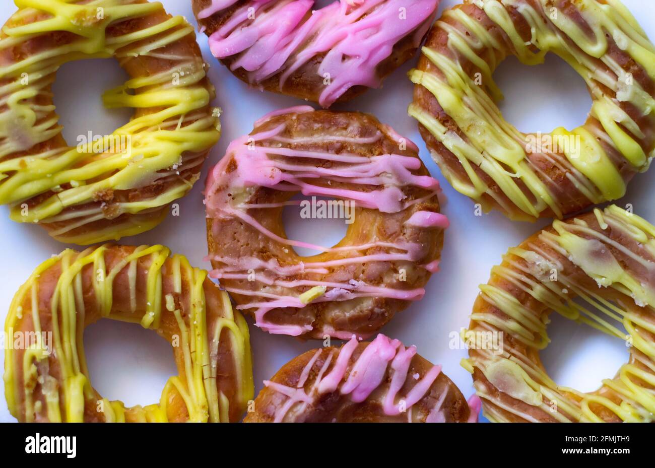 Overhead shot of different flavor donuts on a white plate Stock Photo ...